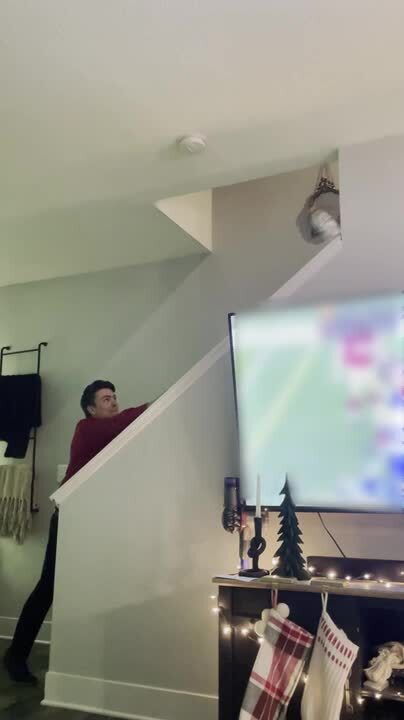 Man Knocks Over Items on TV Table While Playfully Sliding Bottle ...